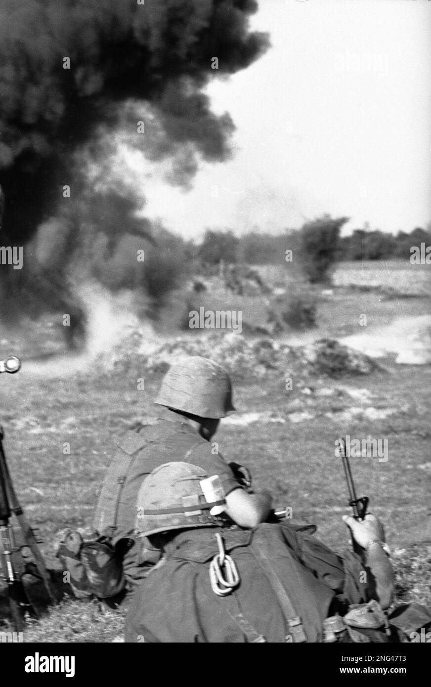 Troops stay clear as smoke from a Viet Cong mine that detonated fills ...