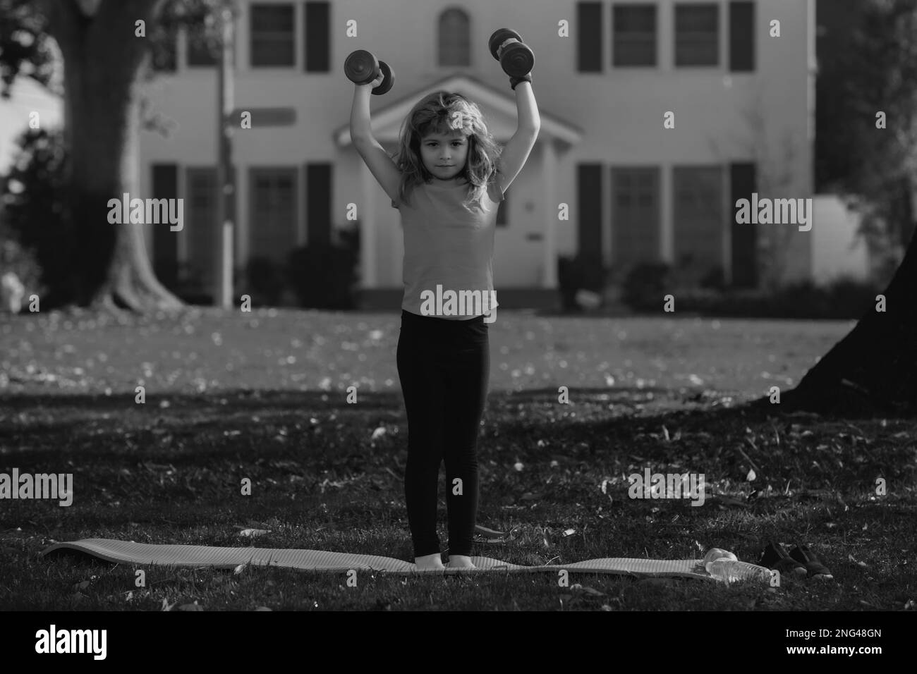 Kids morning sports exercises. Sport children. Sport child with strong biceps muscles. Kids ...