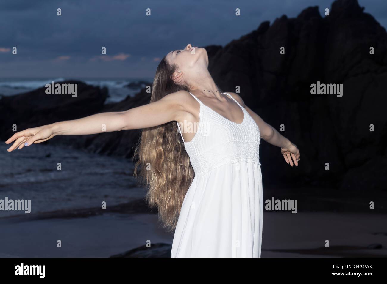 Free woman raising arms to golden sunset. Freedom Stock Photo - Alamy