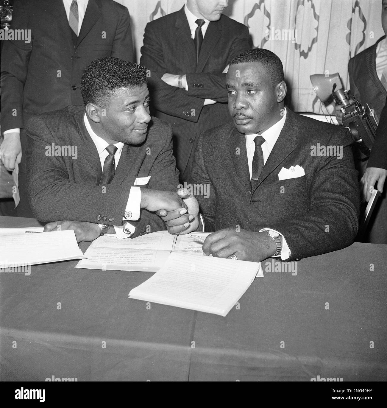 Heavyweight boxing champ Floyd Patterson, left, shakes hands with ...