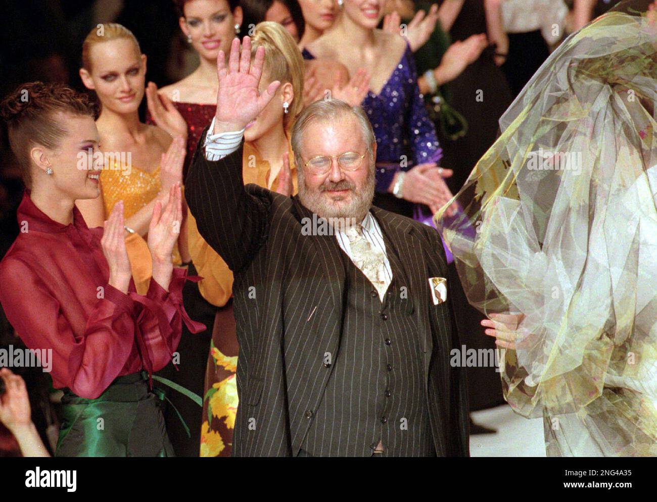 ** FILE ** Italian designer Gianfranco Ferre' waves as models applaud ...