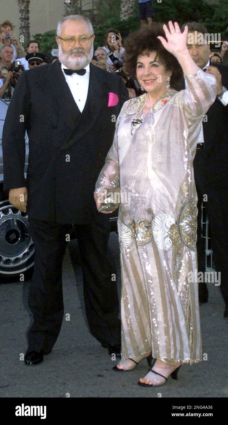 ** FILE ** Hollywood actress Elizabeth Taylor waves as she arrives with ...
