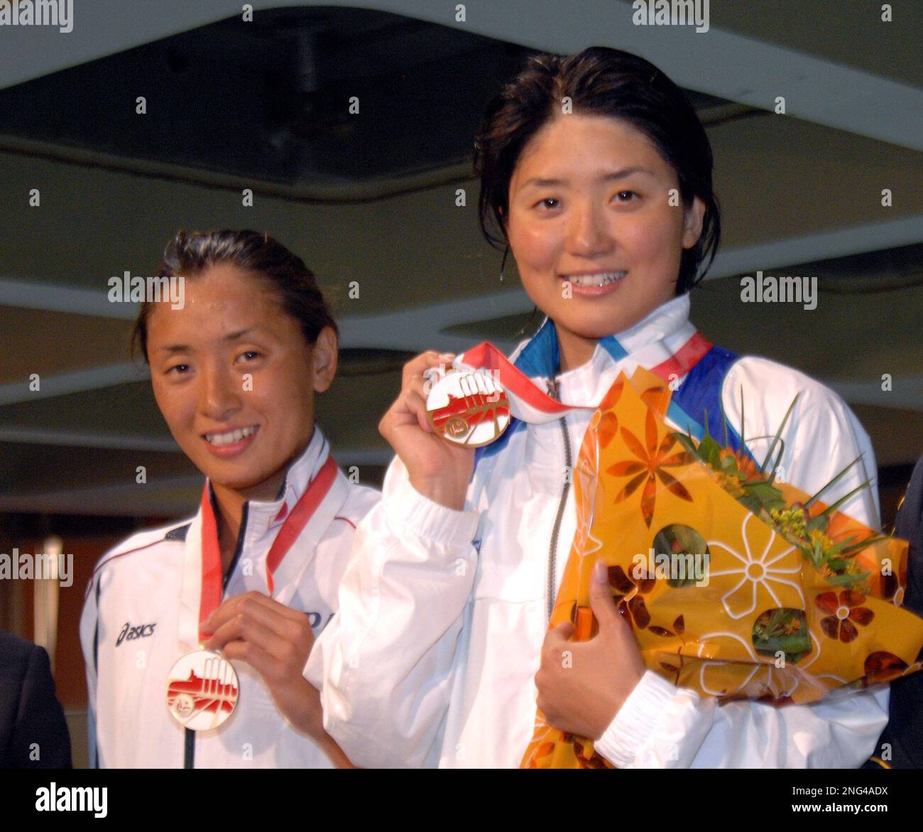 Japan's Reiko Nakamura, right, and Hanae Ito, show their medals after ...