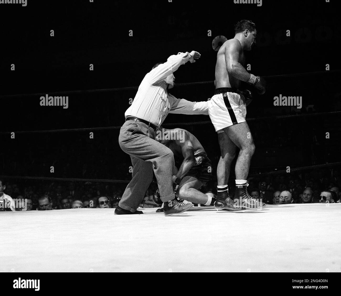 As Joe Louis sags to his knees for the second and last knockdown as ...