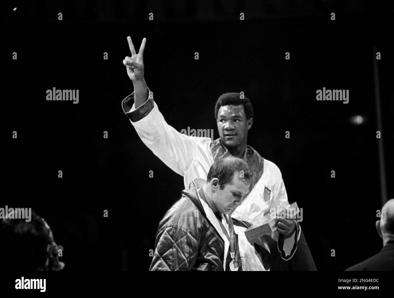 Challenger - and now heavyweight champion - George Foreman flashes a ...