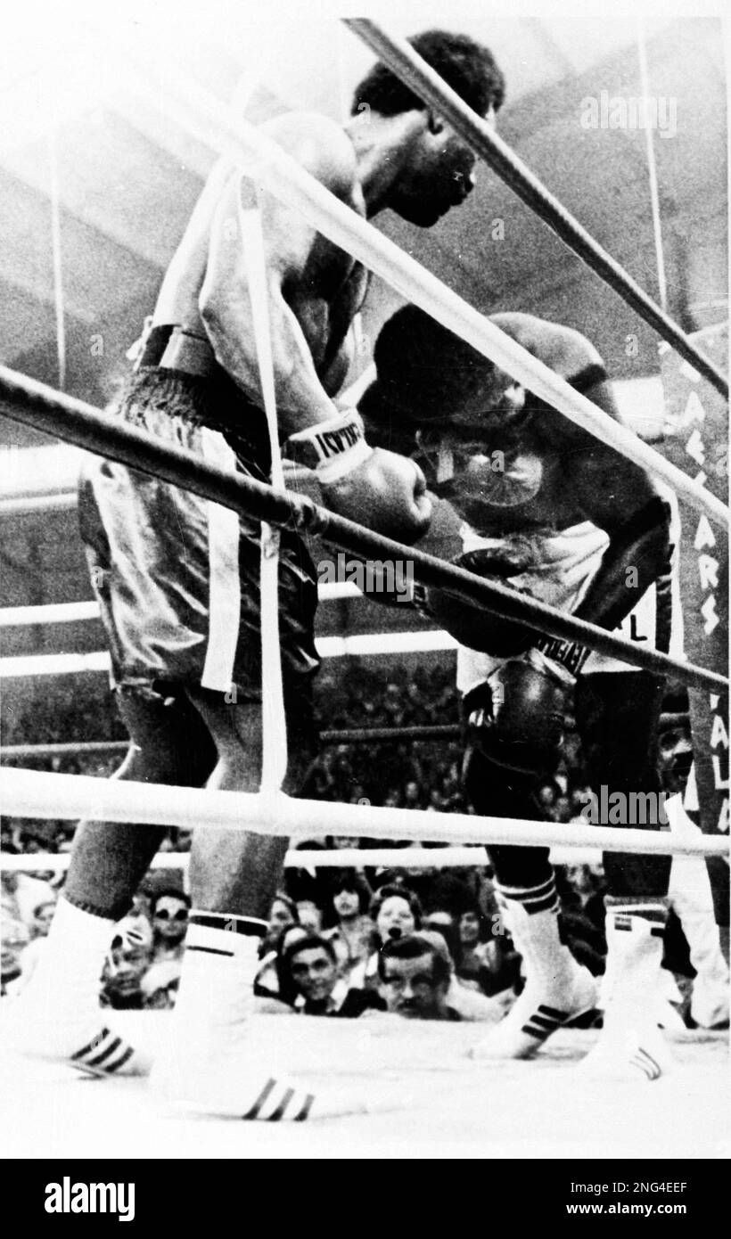 Heavyweight boxer George Foreman delivers a left hook to the chin of ...