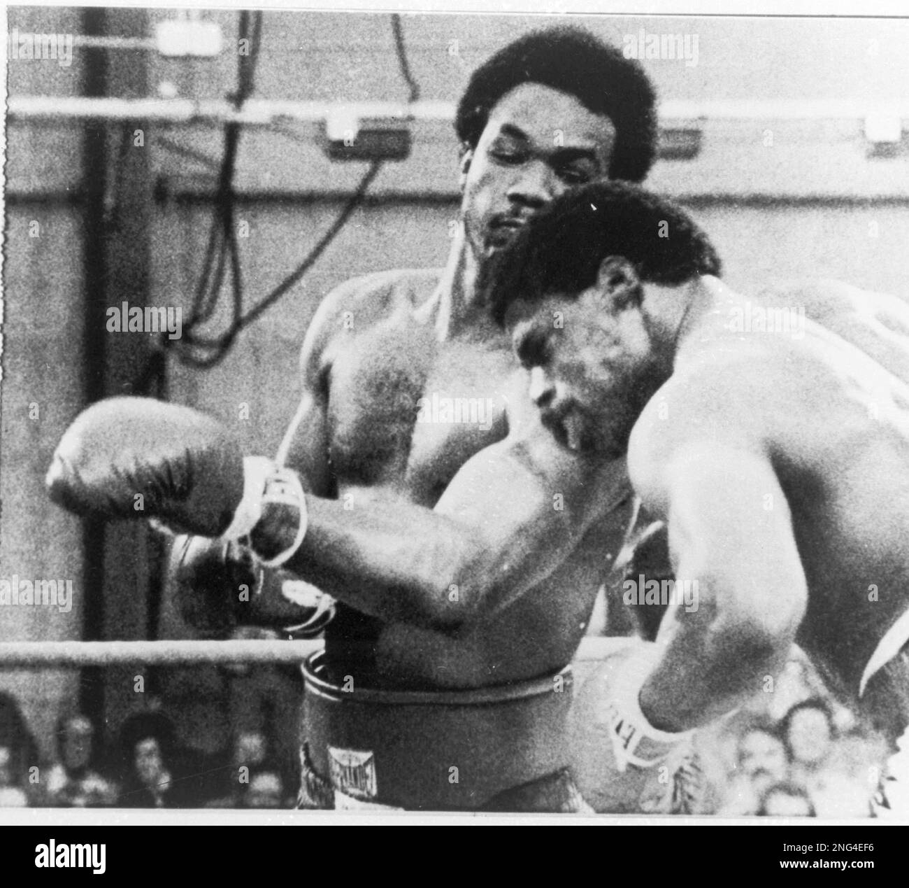 Heavyweight boxer George Foreman delivers a shot to the chin of Ron ...
