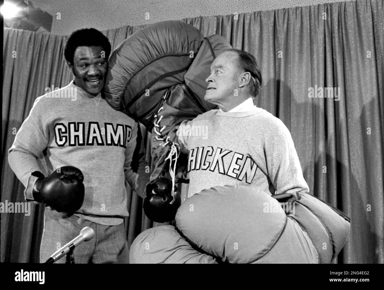 Heavyweight boxer George Foreman takes a "punch" from the large boxing ...