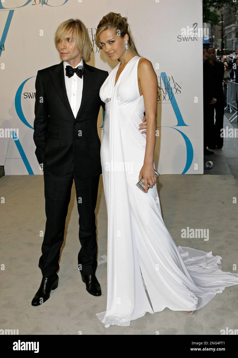 Designer Marc Bouwer, left, and model Petra Nemcova pose for a photo at ...