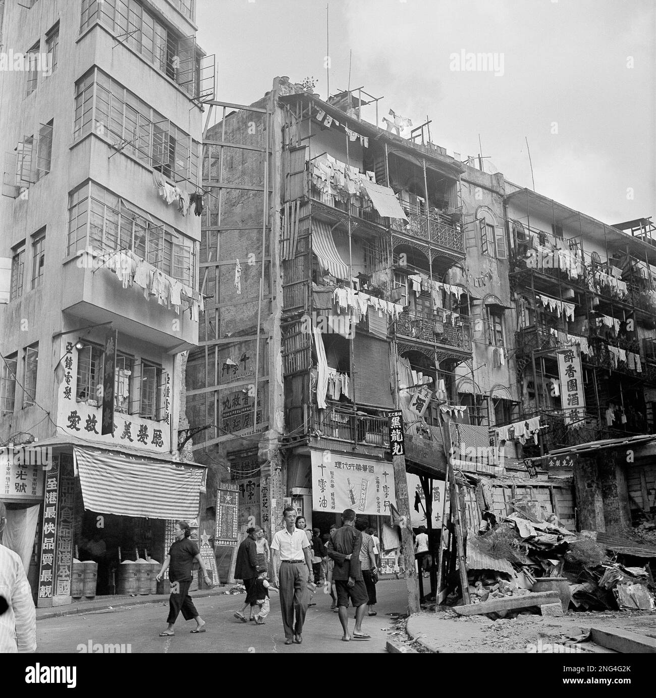 Street fronts of the tenements in the Chinese district of Hong Kong ...