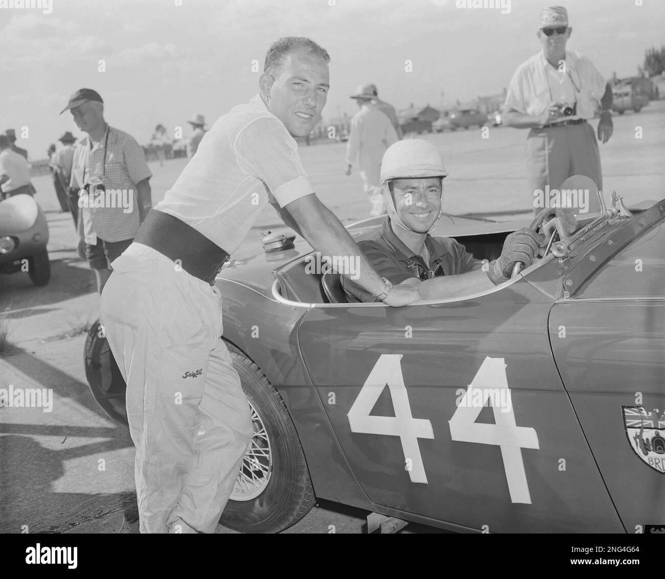 Stirling Moss of London, England, standing, and Lance Macklin, also of ...