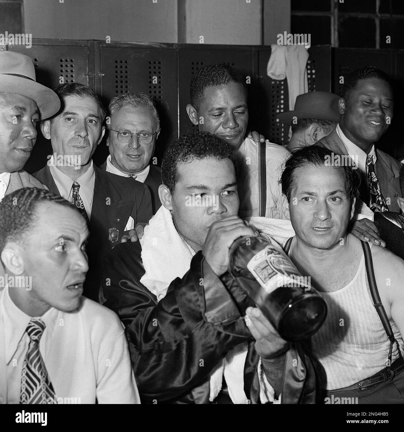 World's Heavyweight champion Joe Louis takes a long drink of water in ...