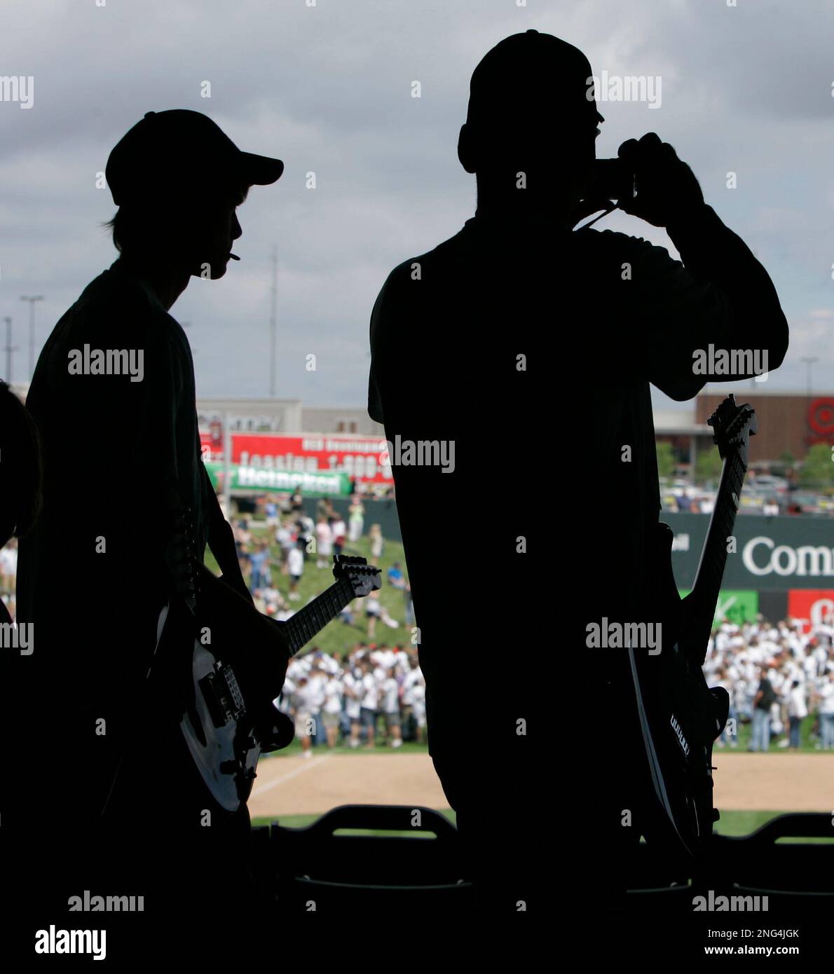 Unidentified guitarists photograph the scene at Community America ...