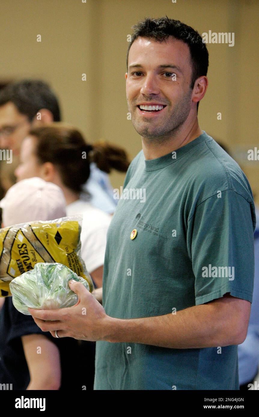Actor Ben Affleck sorts food during a visit to the Greater Boston Food ...