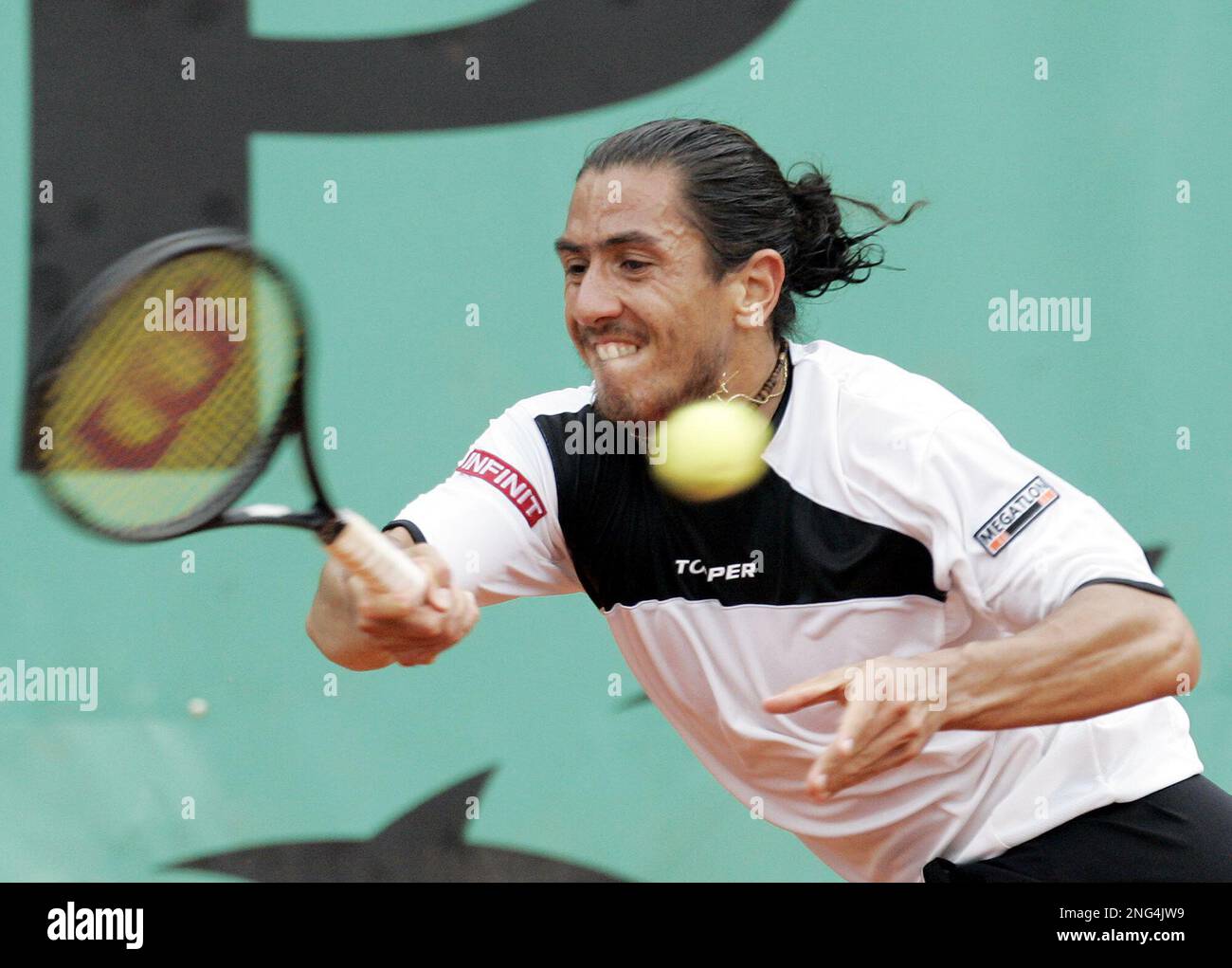 Argentina's Guillermo Canas returns the ball to compatriot Juan Monaco ...
