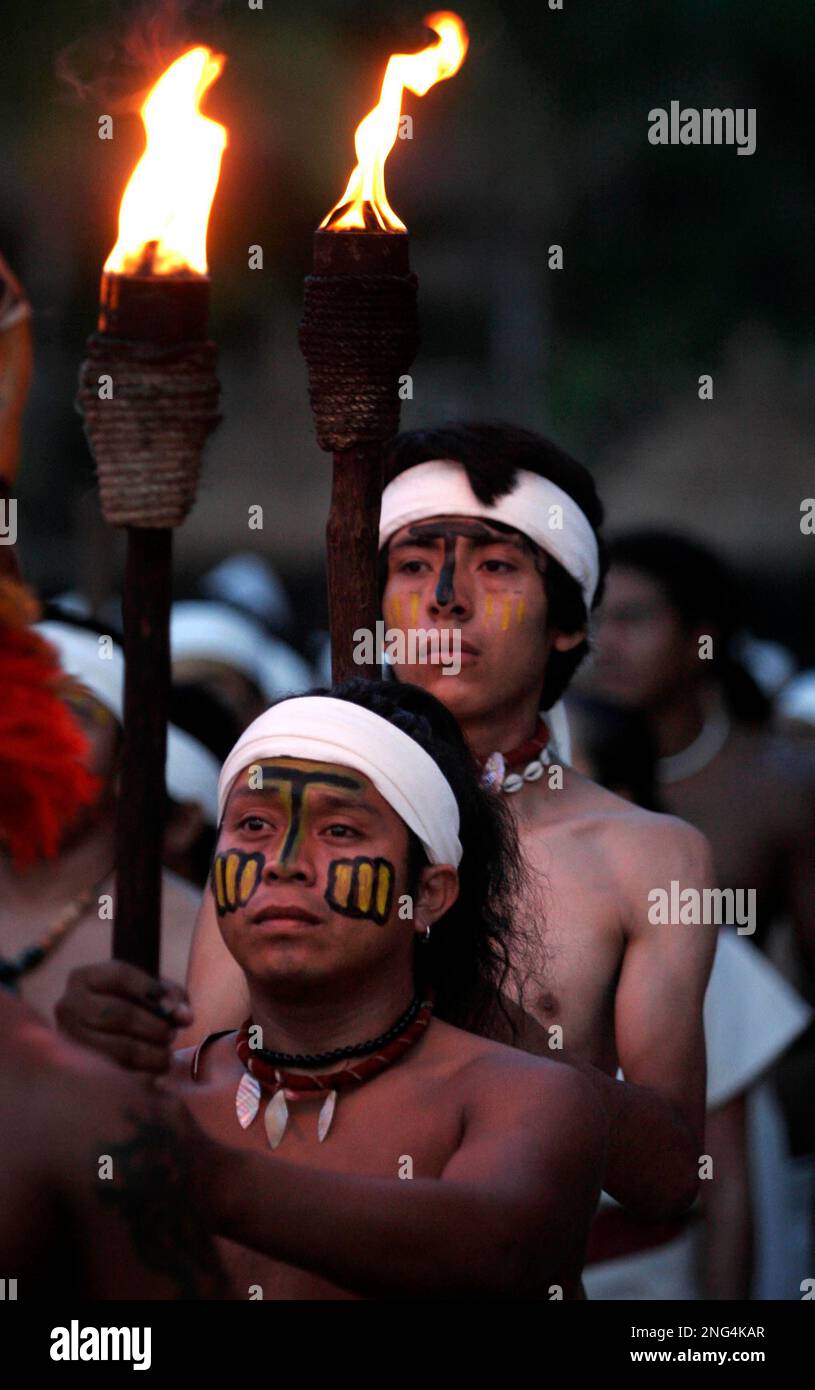 Men dressed in traditional Mayan clothes take part in a ceremony ...