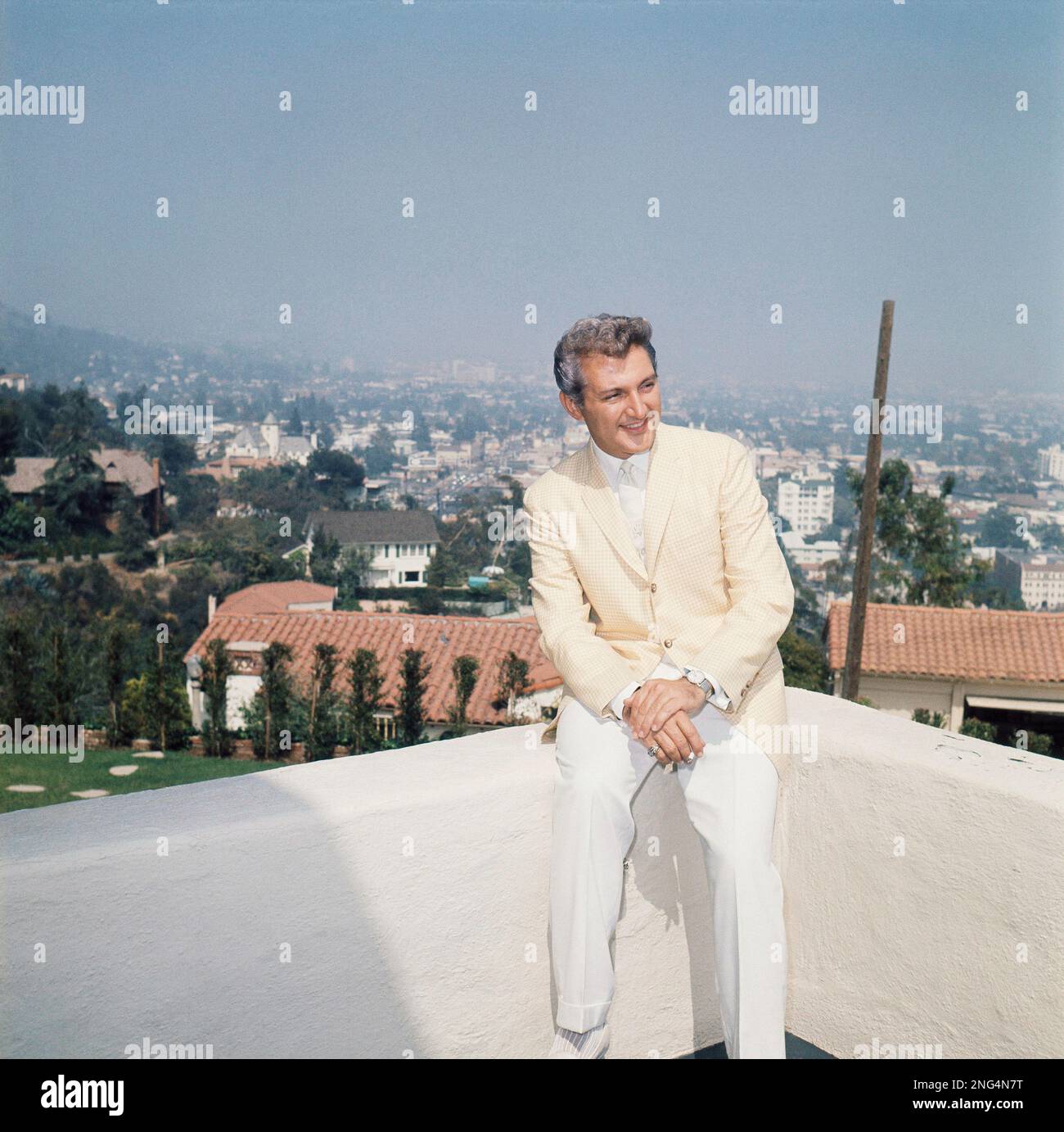 Entertainer Liberace sits on a stone balcony at his Hollywood Hills ...