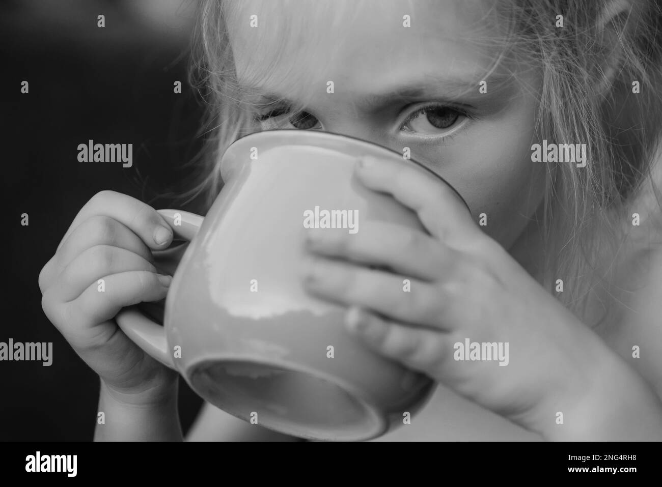 Girl drinking something. Water. Juice. Milk. Happy child in summer in ...