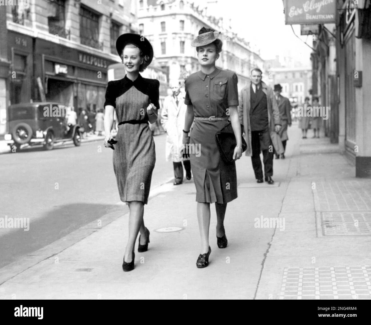 Models wear the first utility dresses designed by Norman Hartnell in a ...