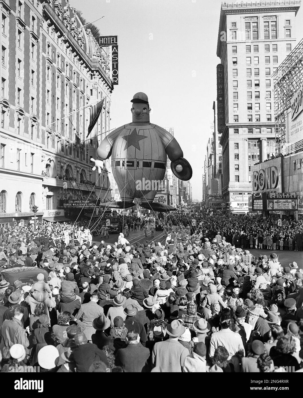 A giant baseball player float moves down 7th Avenue during the Macy ...