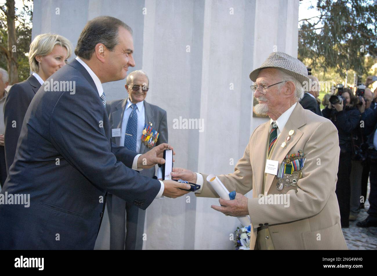 Greek Prime Minister Kostas Karamanlis gives Keith Hooper, who served ...