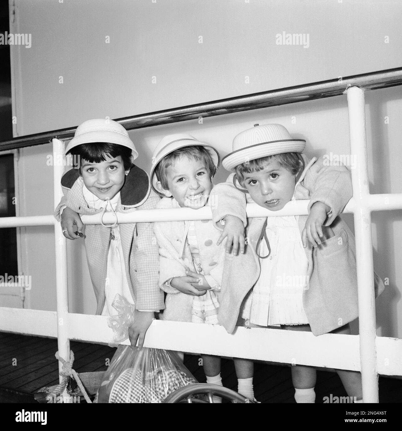 Three sisters from Bari, Italy appear to have mixed emotions as they ...