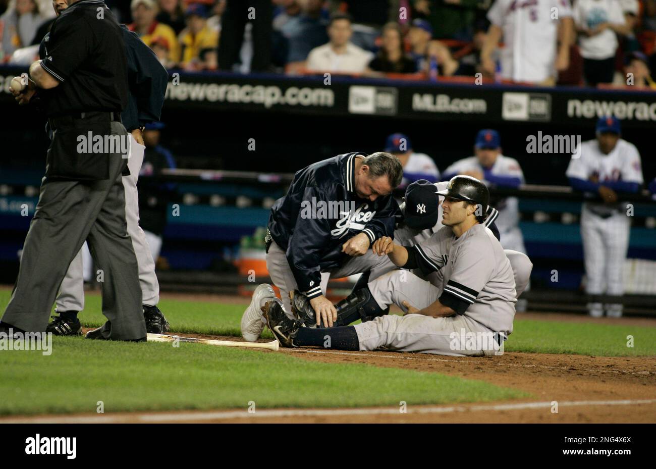 New York Yankees first baseman Doug Mientkiewicz holds his leg in pain ...