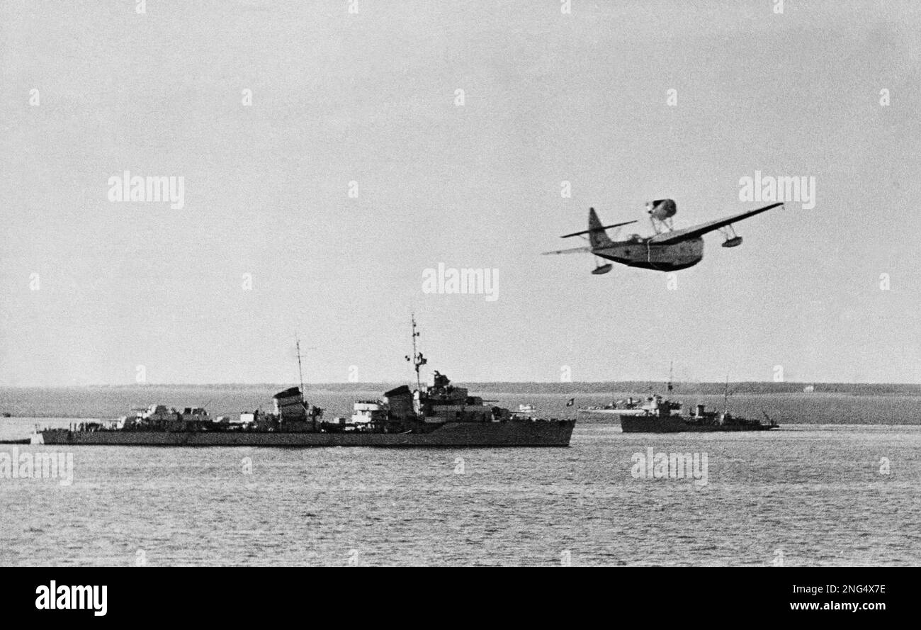 A pusher-type flying boat circles over ships of the Russian Navy on ...