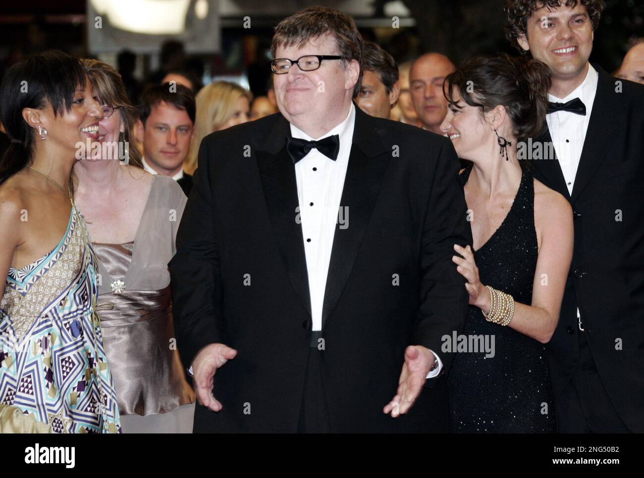 American director Michael Moore, center, arrives for the screening of ...