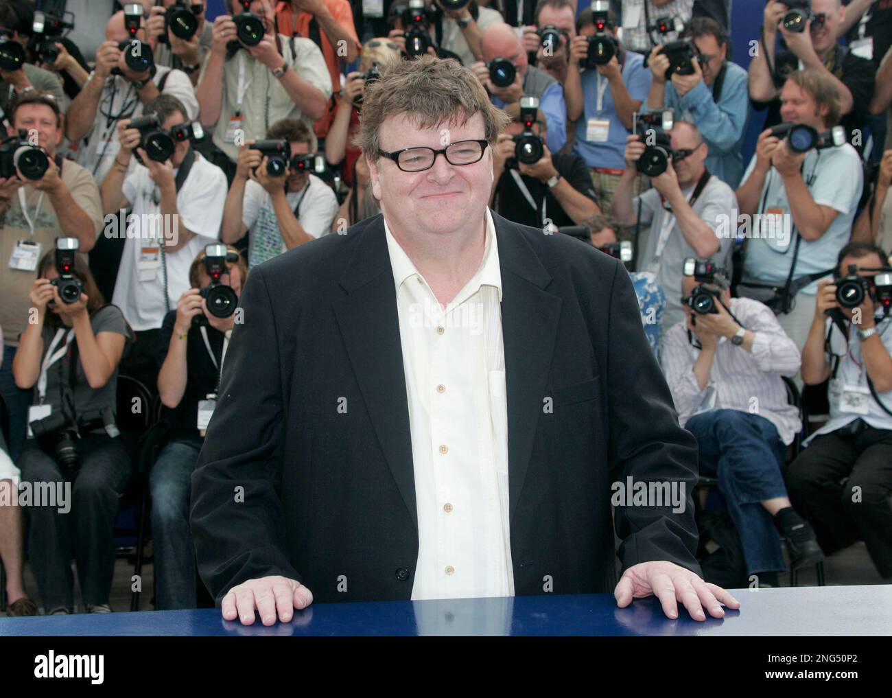 American director Michael Moore pose during a photo call for the film ...