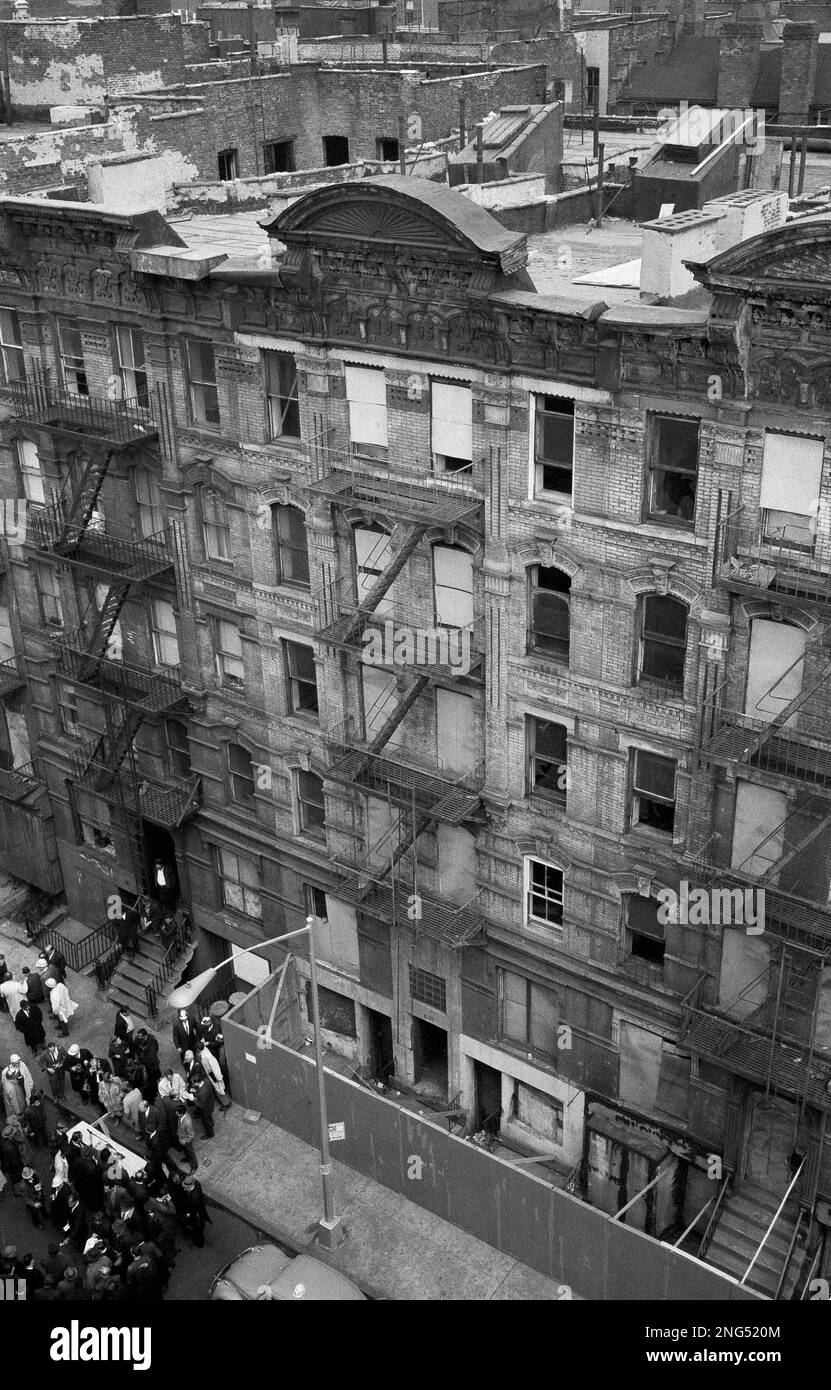 Wooden panel covers hole ripped in roof of slum tenement on New York ...