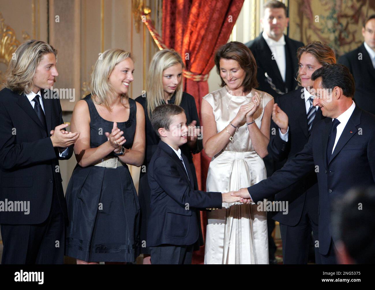 New French President Nicolas Sarkozy, right, shakes hands with his son ...