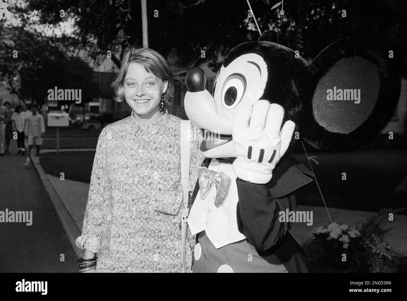Actress Jodie Foster is greeted by Mickey Mouse as she arrives at ...