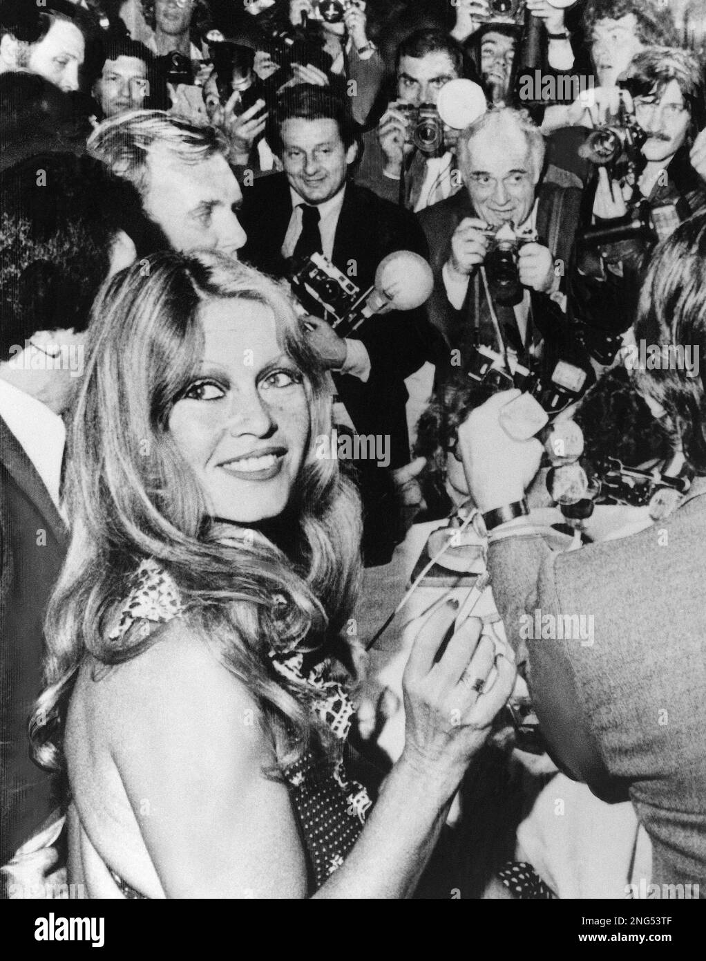 With Photographers crowding the ranks before her, actress Brigitte ...