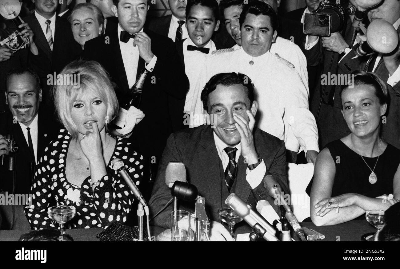French Actress Brigitte Bardot ,left, puts her finger into mouth for a ...