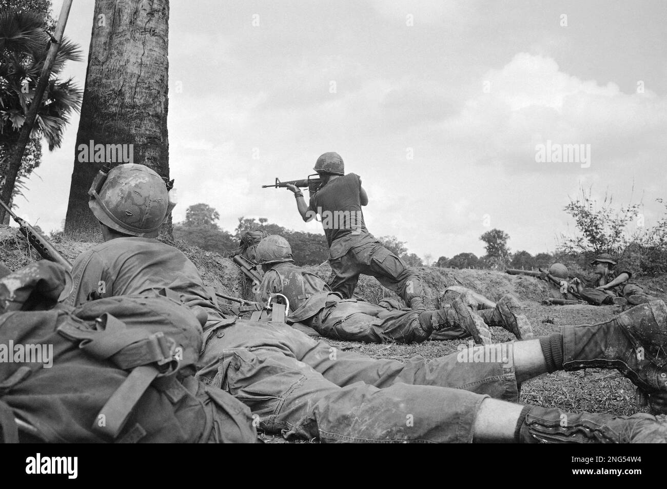 An American soldier of the 25th Infantry Division stands up to fire a ...