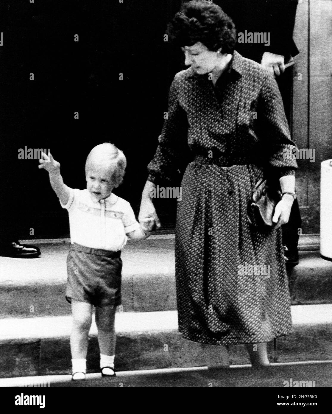 Britain's Prince William waves as he is led by Royal nanny Barbara ...