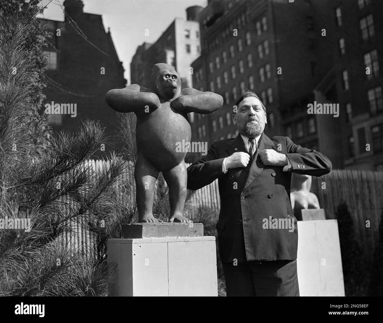 Artist Adolf Wolff, strikes the same pose he gave his sculpture ...