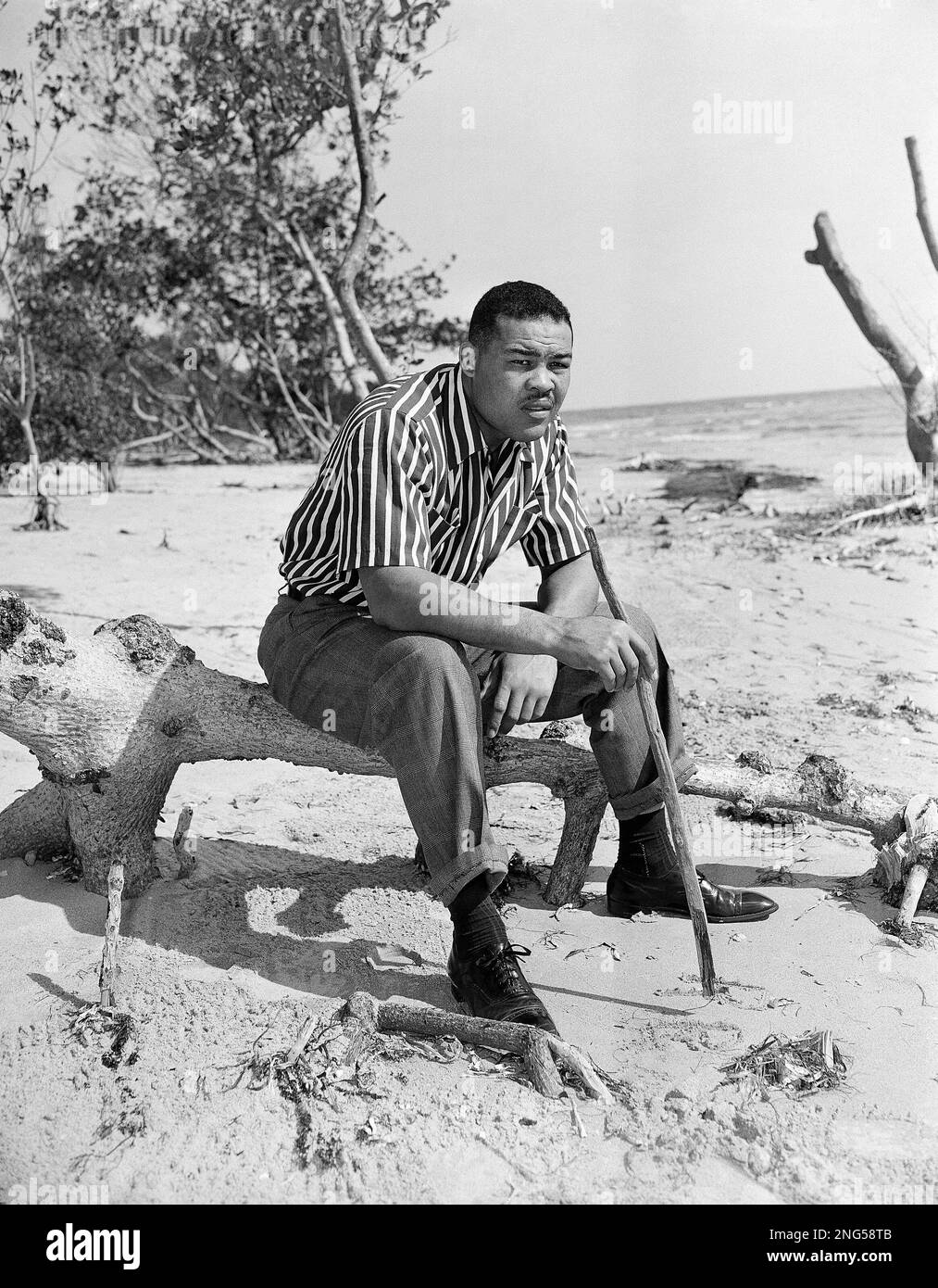 Boxer Joe Louis, relaxes on the beach at Miami, Florida on January 24 ...