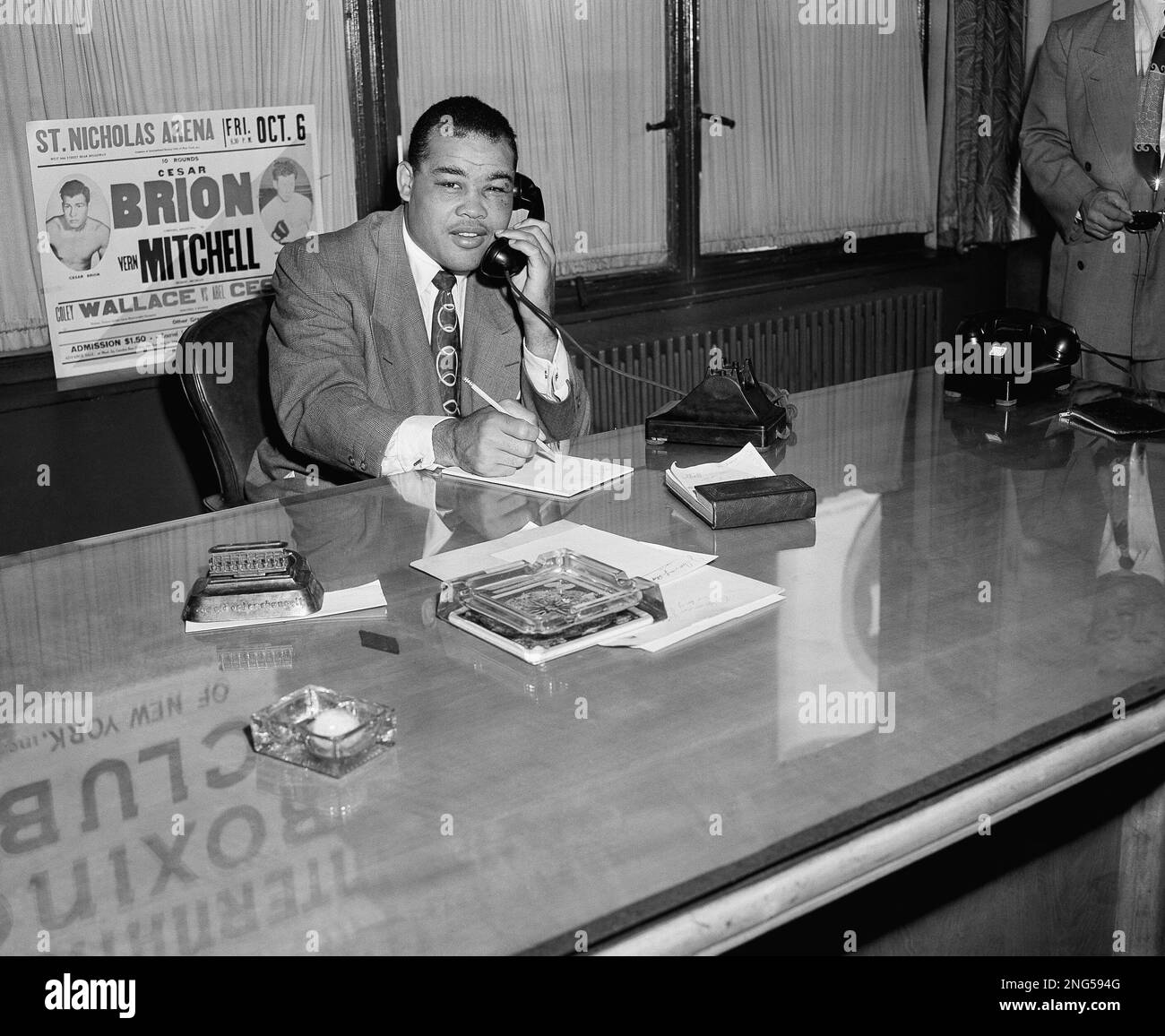 Boxer Joe Louis, on the phone, is back to work at office at the ...