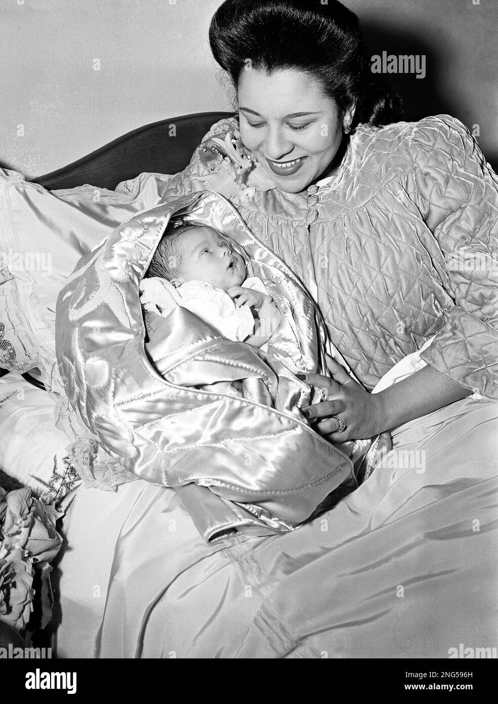 Snuggled beside her mother, Marva, Jacqueline Louis, four-day-old ...