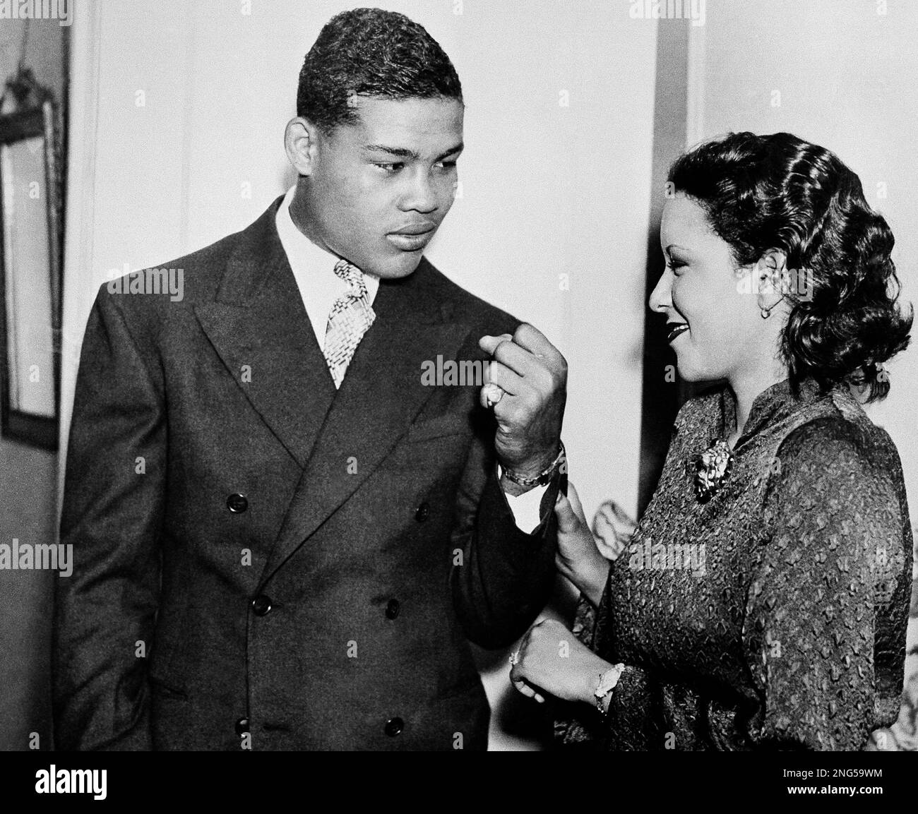 Nonchalant as usual, Joe Louis shows his admiring wife Marva the brutal ...