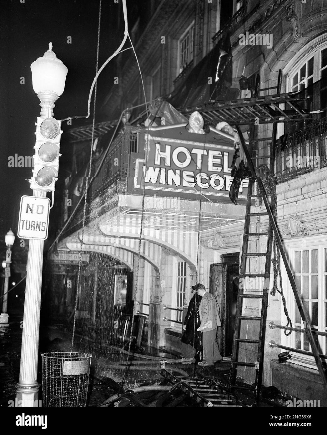 The body of a fireman hangs from the marquee of the Winecoff Hotel in Atlanta, Ga., Dec. 7, 1946 ...