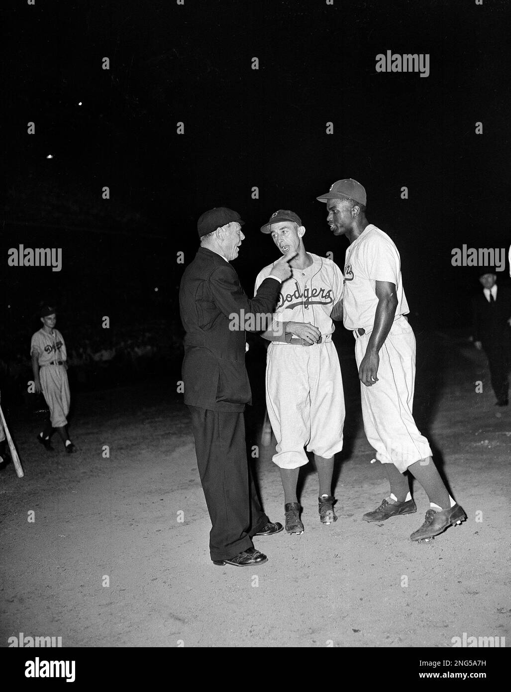 Jackie Robinson, second baseman of the Brooklyn Dodgers, right, argues ...
