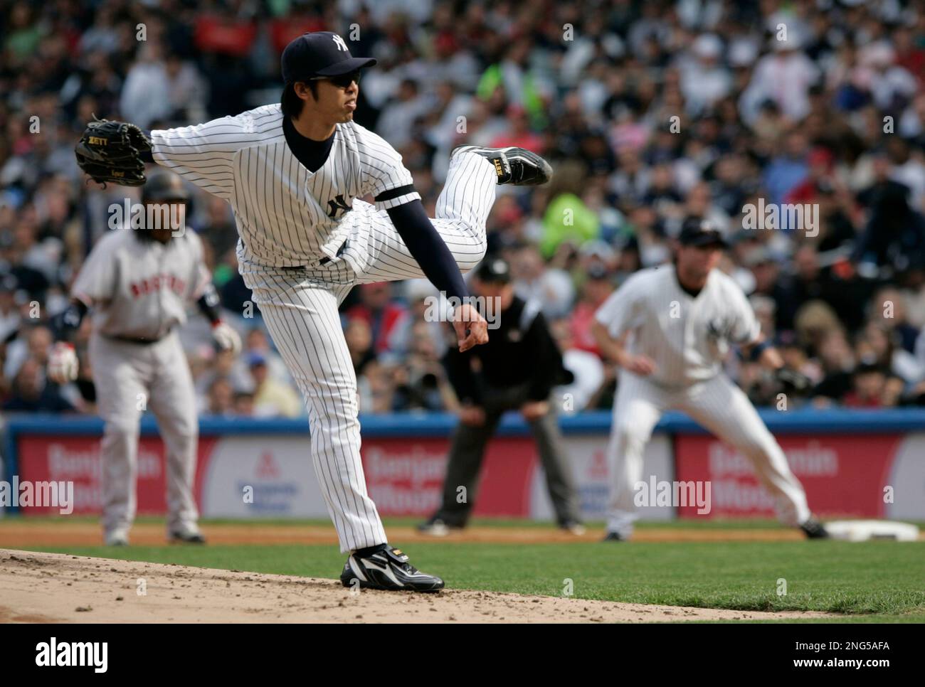 New York Yankees pitcher Kei Igawa follows through on a pitch against ...