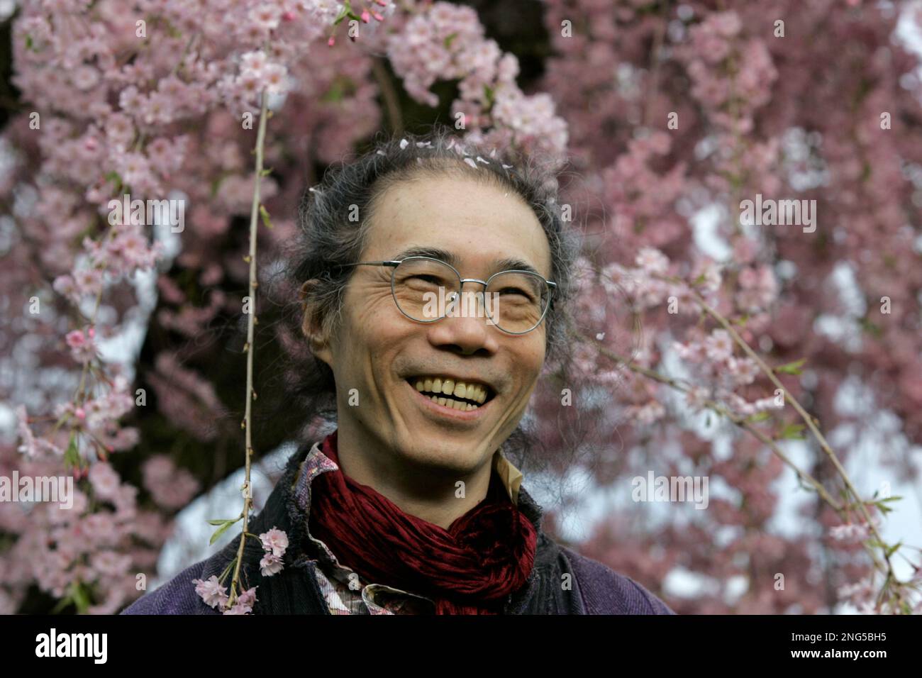 Chinese-born painter Szeto Keung, who specializes in painting flowers ...