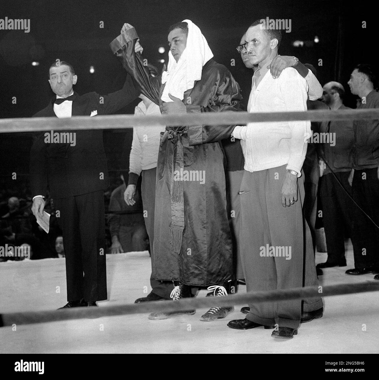 Announcer Harry Balogh raises the right arm of Joe Louis after the ...