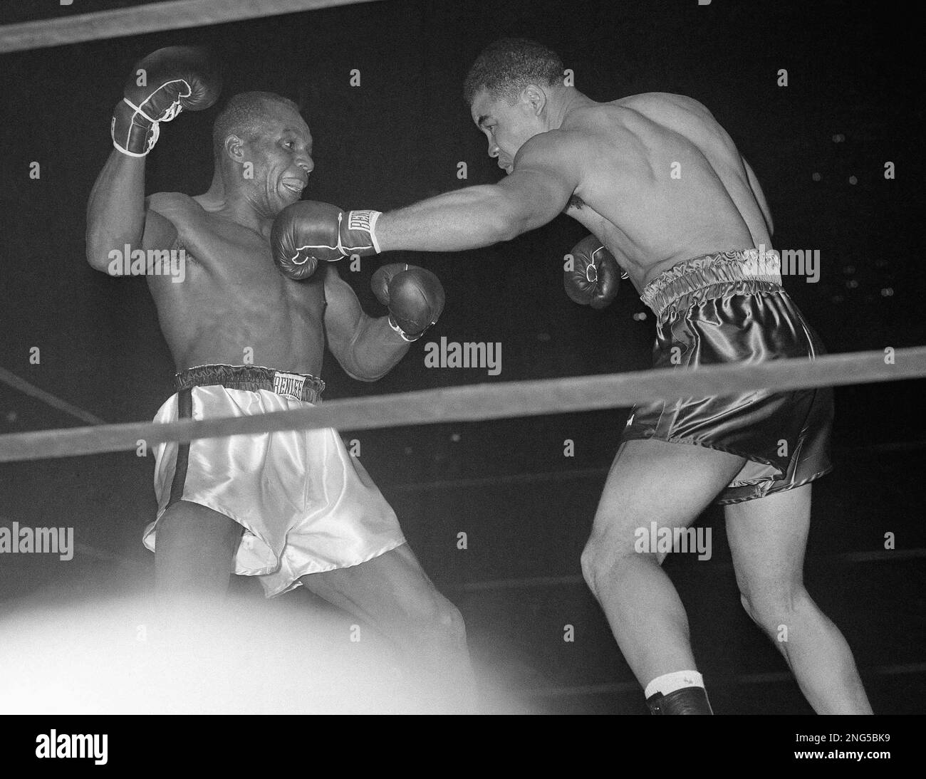 Heavyweight champion Joe Louis bounces a left off the chin of ...