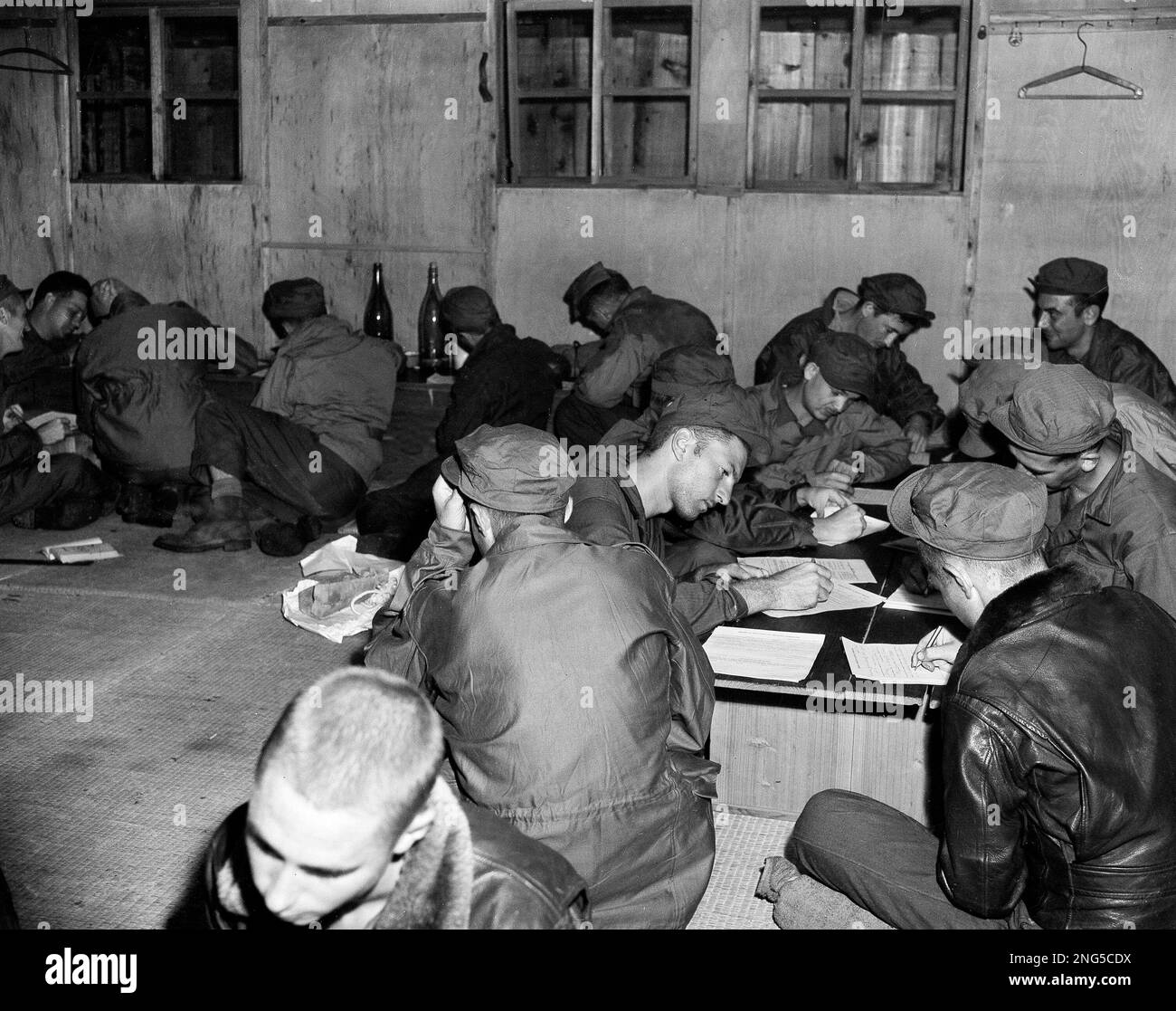 American B-29 and Navy pilots answer a questionnaire before leaving ...