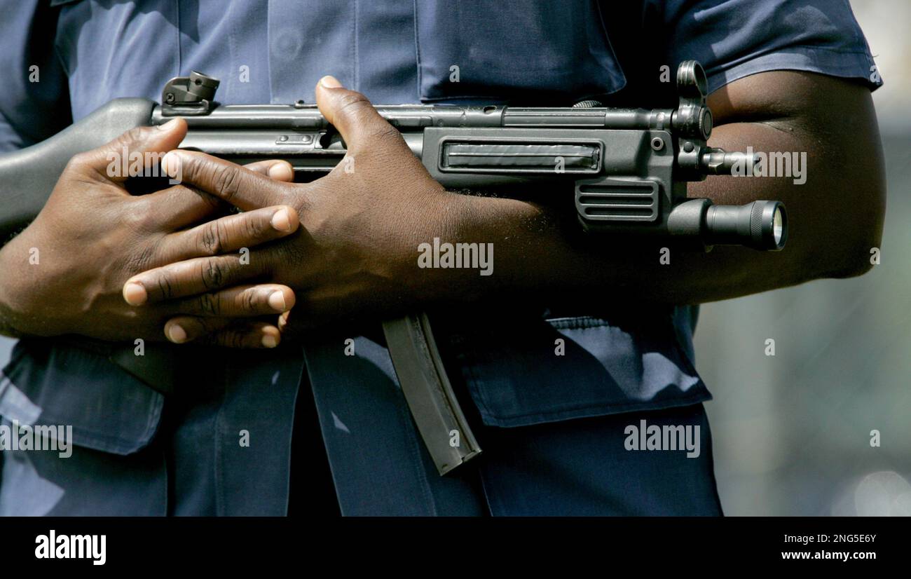 An armed local police officer patrols during an England team training ...